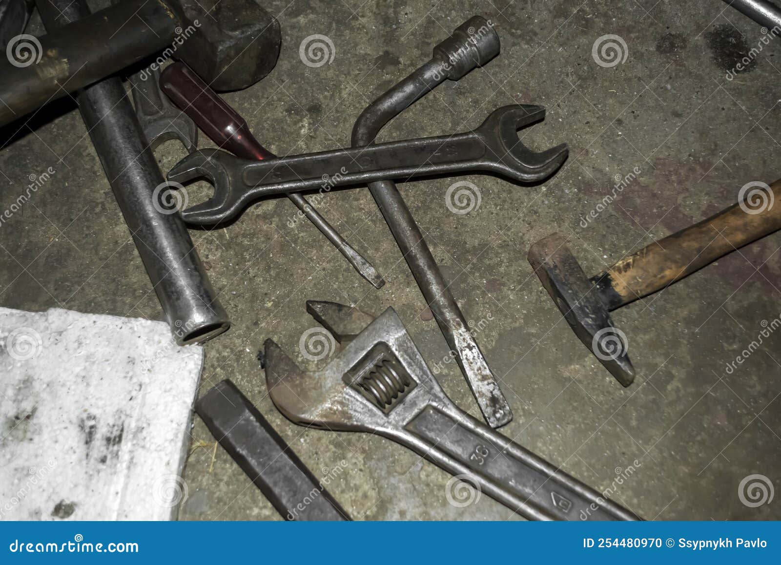 On Concrete is a Dirty Working Tool. Scattered Tools. There is a Wrench ...
