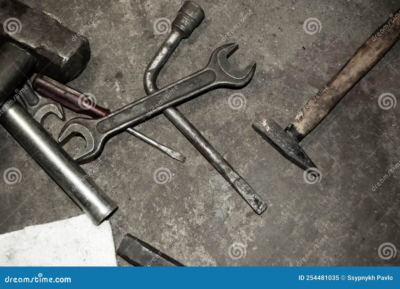 On Concrete is a Dirty Working Tool. Scattered Tools. There is a Wrench ...
