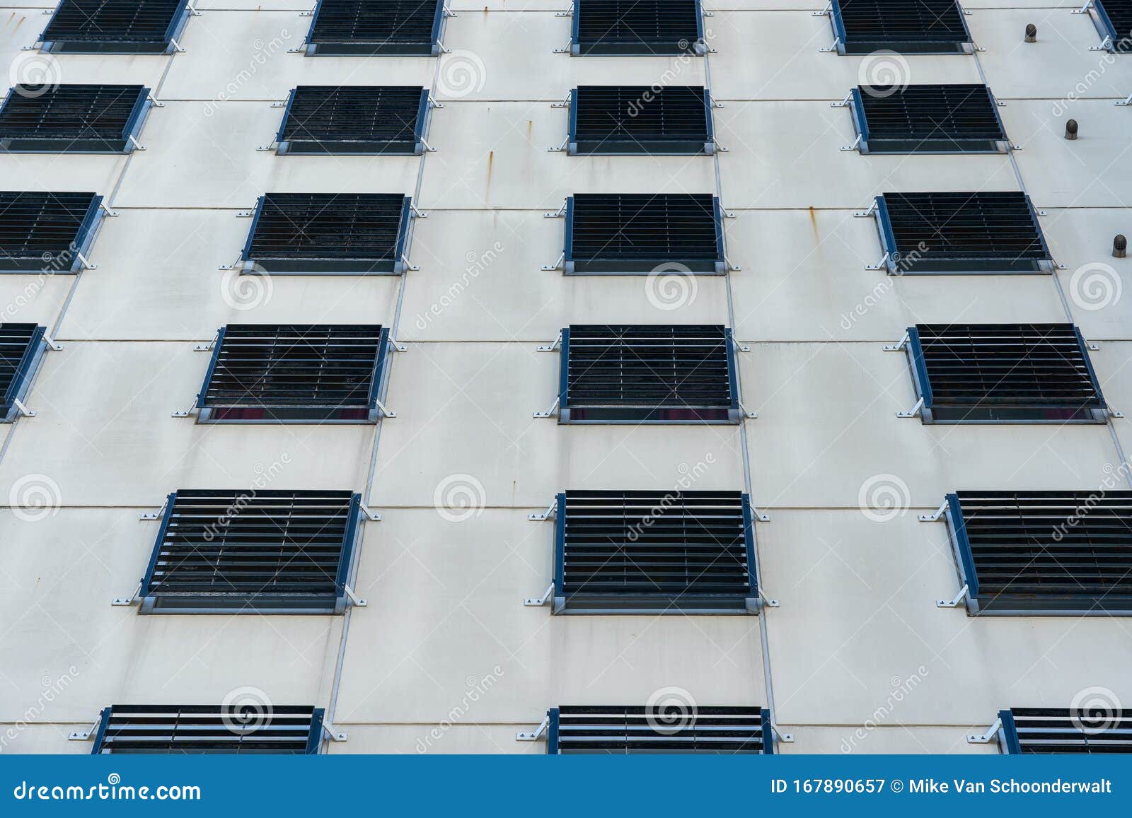 The Concrete Facade of a Prison. the Windows are Fitted with Bars so ...