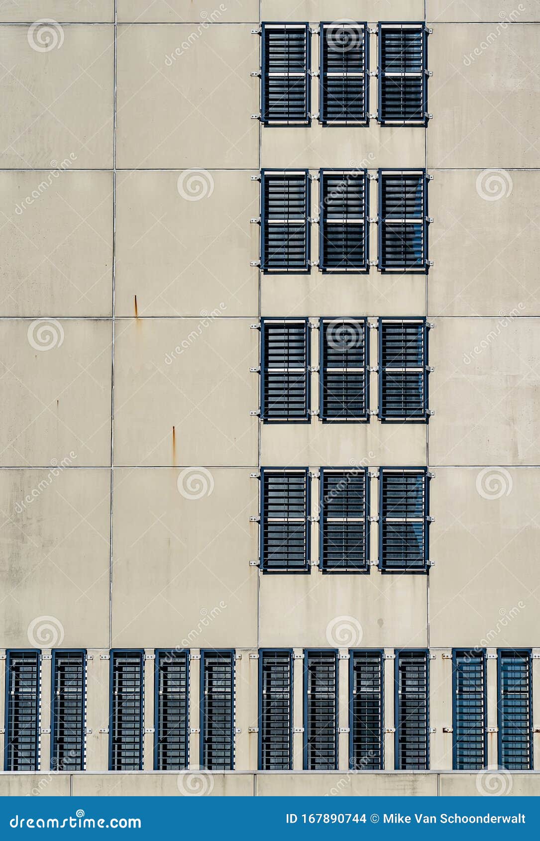 The Concrete Facade of a Prison. the Windows are Fitted with Bars so ...