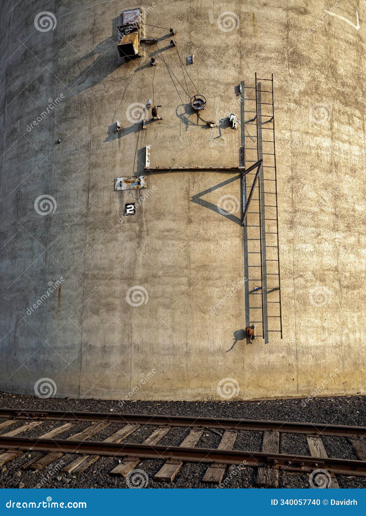 A Concrete Grain Storage Bin with a Ladder and Platform To Access the ...