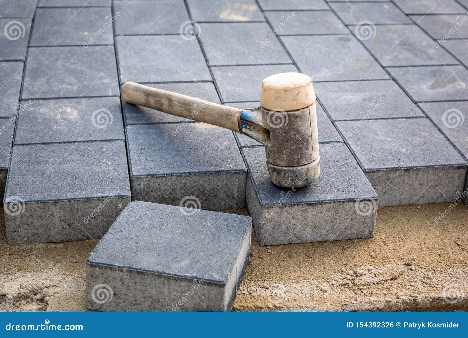 Concrete Paver Blocks Laid with Rubber Hammer Stock Photo - Image of ...