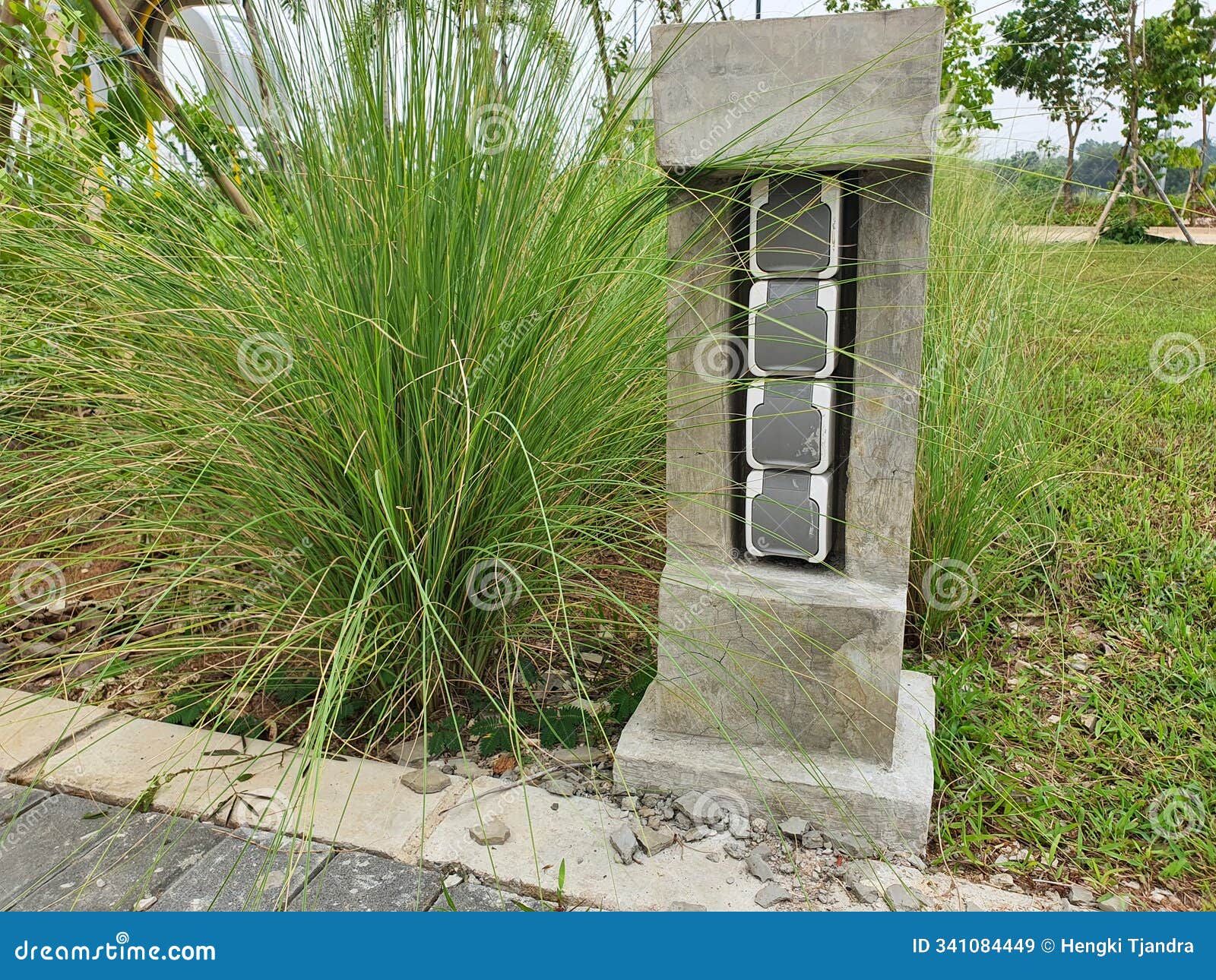 A Concrete Pillar with Recessed Electrical Outlets in a Park or Garden ...