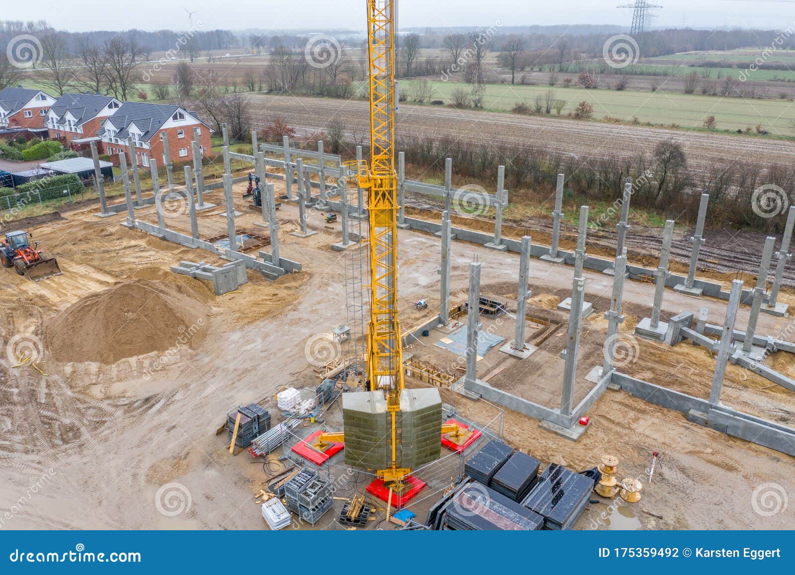 Concrete Pillars are Erected on a Large Construction Site Using a Crane ...