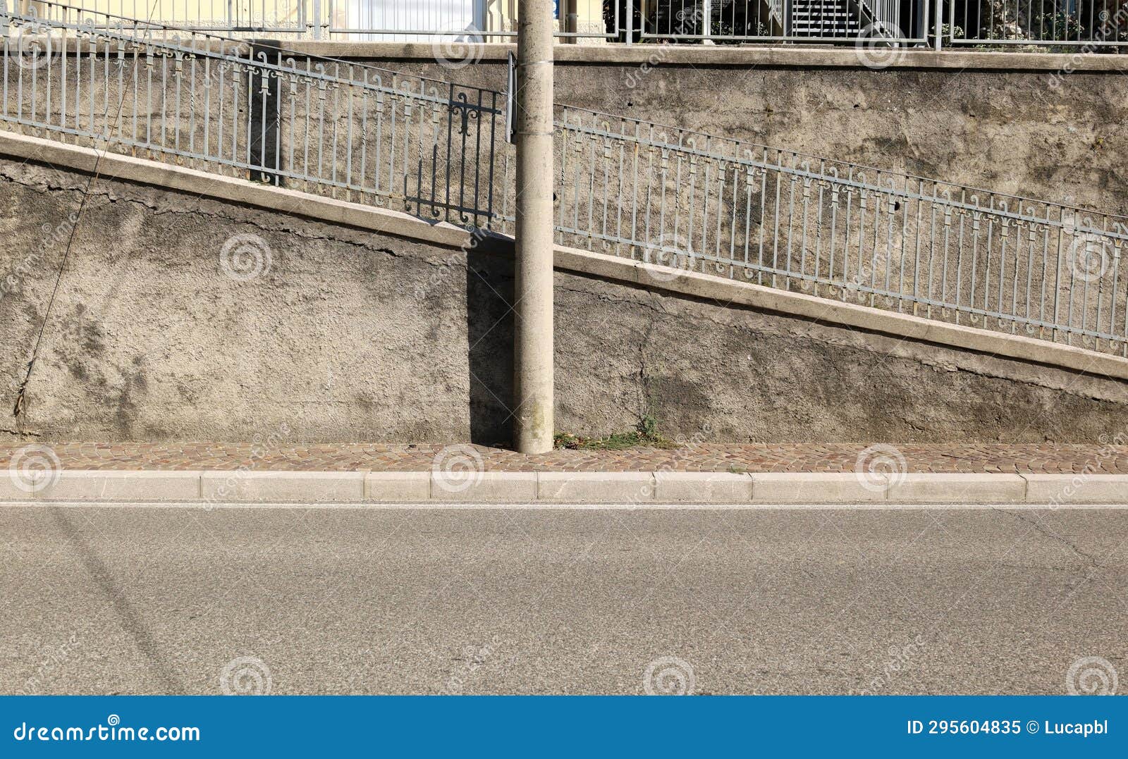 Concrete Pole on Sidewalk with Stairs and Railing on a Rough Cement ...