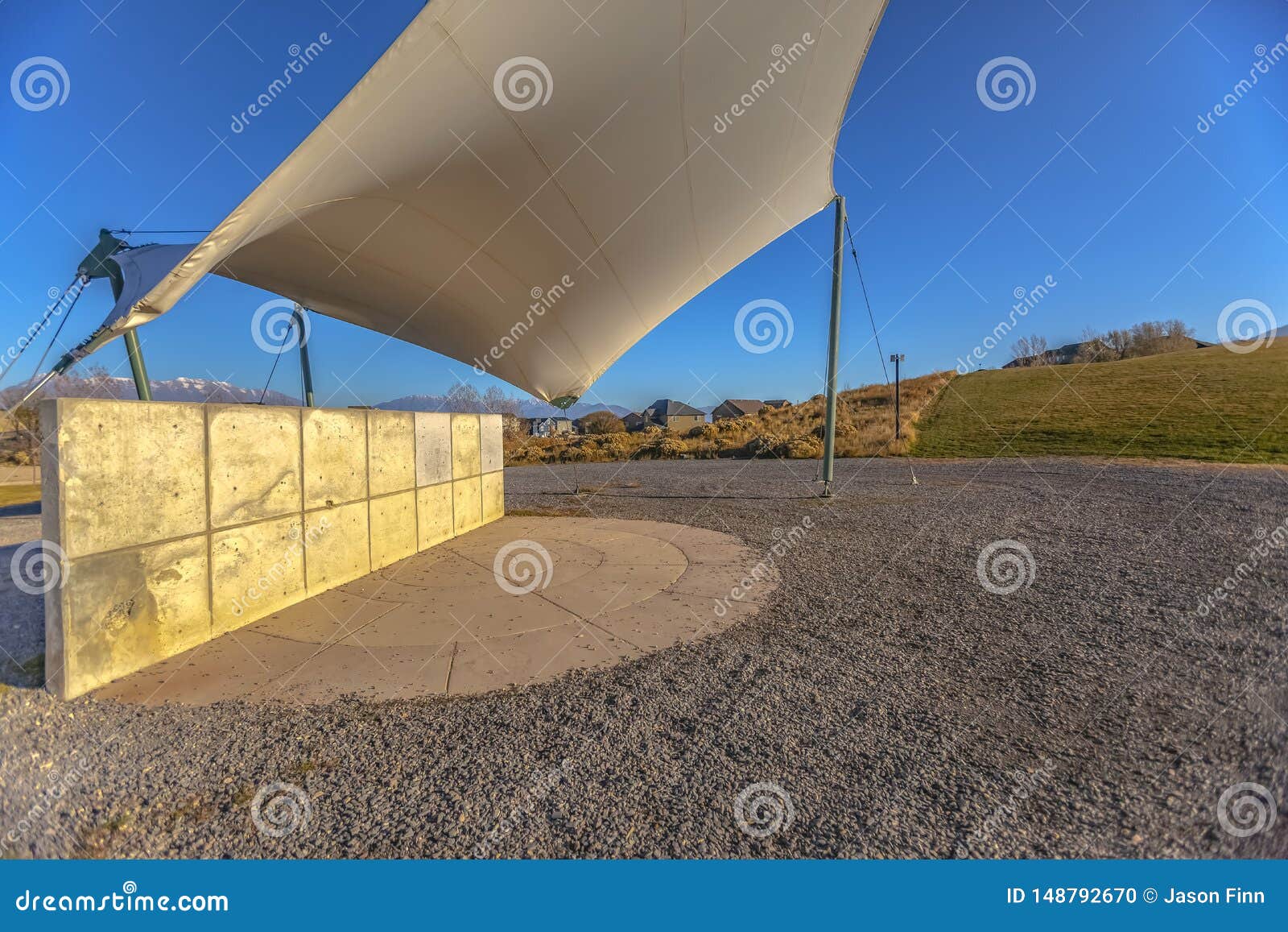 Concrete Rectangular Structure on a Rocky Ground Under a White Canopy ...