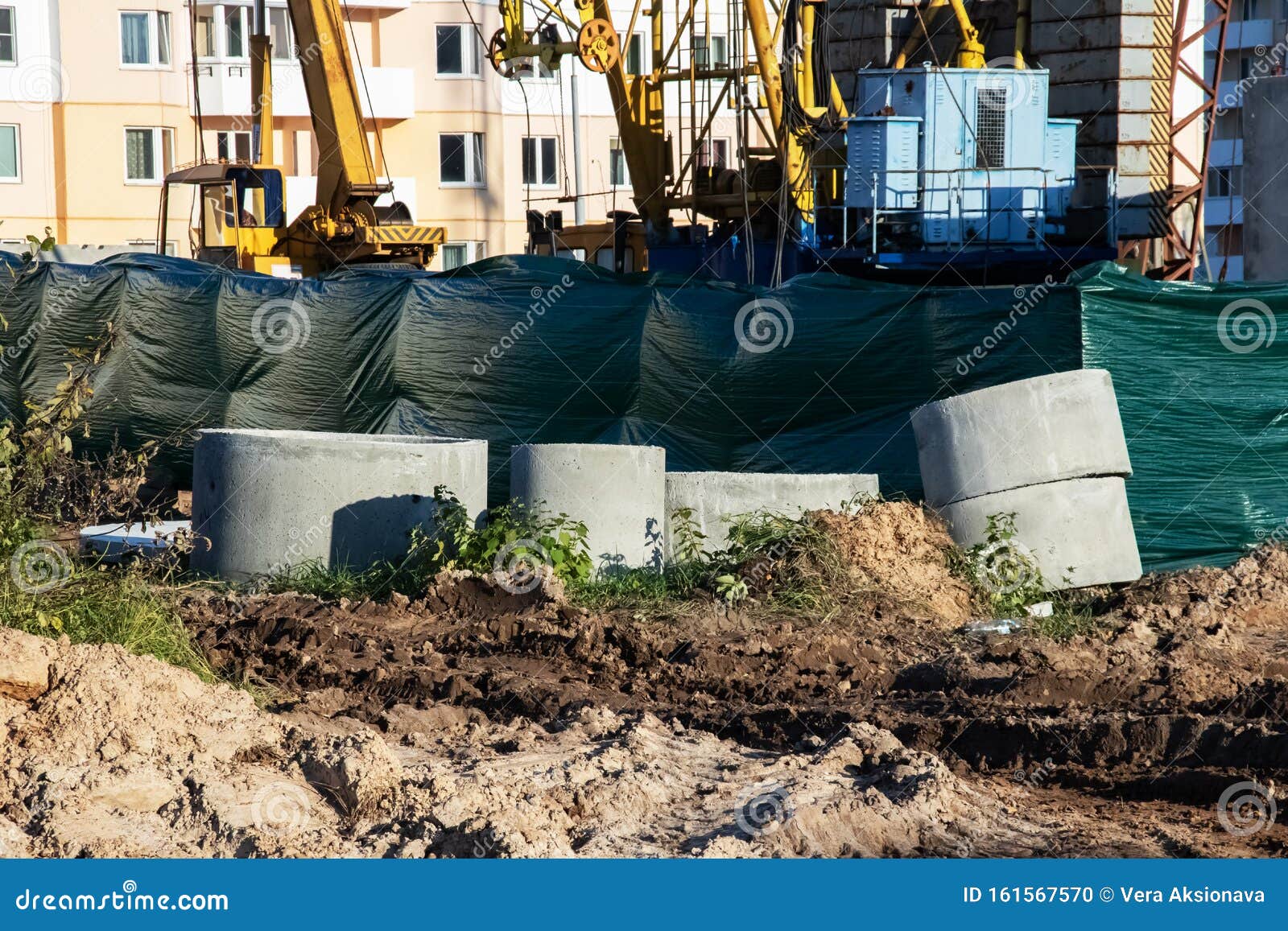 Concrete Rings and Machinery at Construction Site Stock Photo - Image ...
