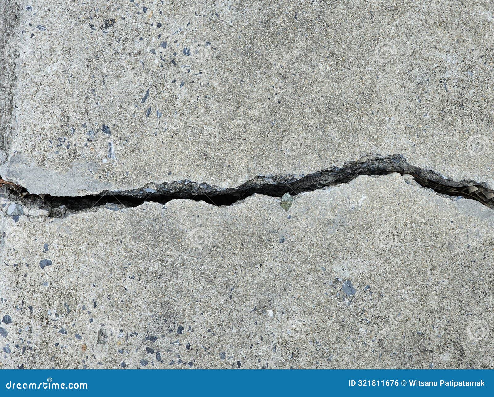 Concrete Road Surface Exhibits Significant Cracking, Indicating ...