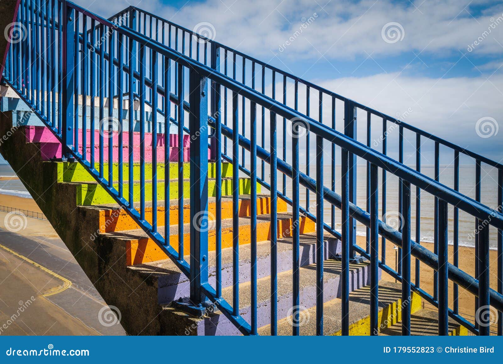 Concrete Steps Painted Bright Rainbow Colours with a Blue Railing ...