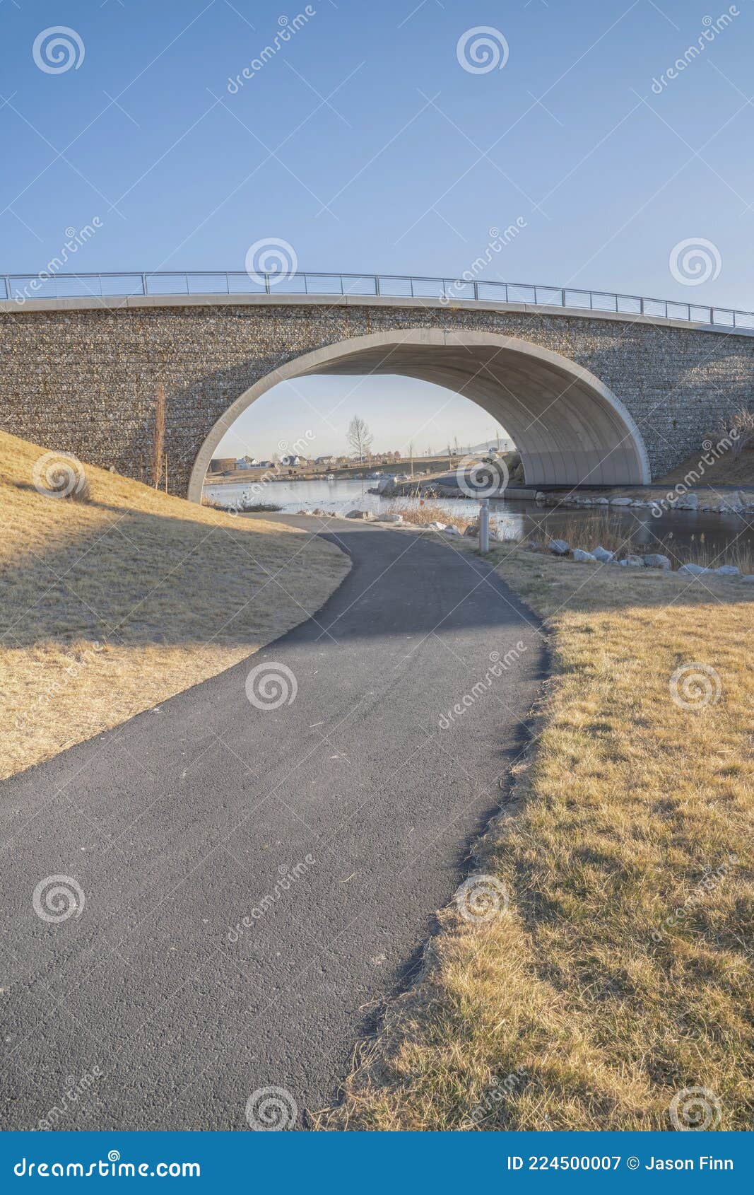 Concrete Trail in the Middle of a Grass with a View of an Arched Bridge ...