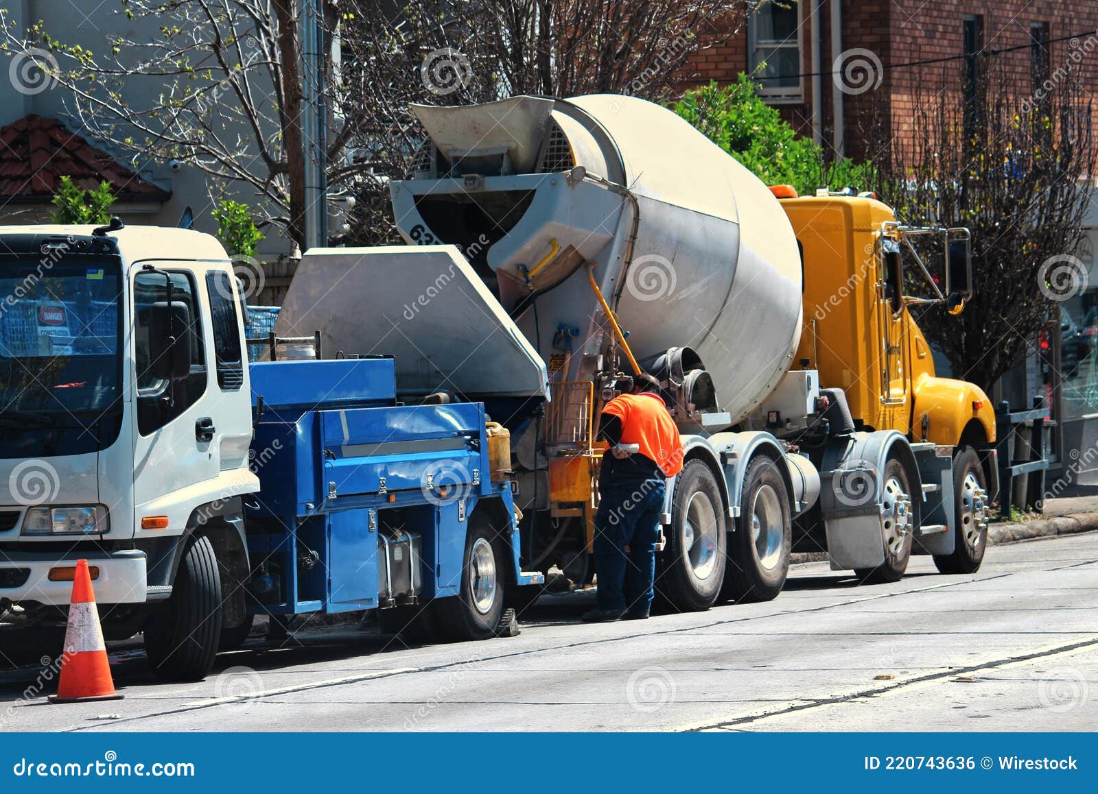 Concrete Truck Unloading Its Liquid Concrete into a Concrete Pumper ...