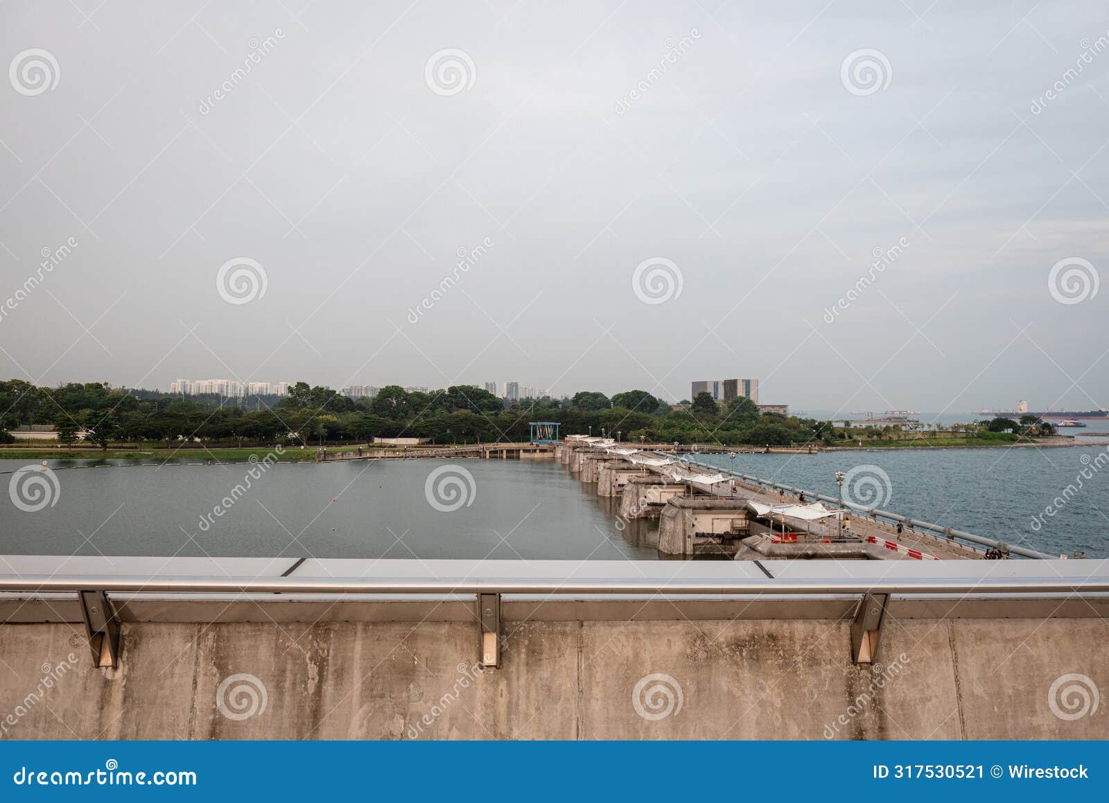 Concrete Walls and Railings by the Water Next To a Dock. Stock Image ...