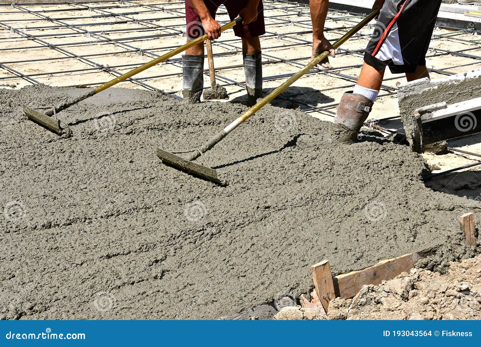 Concrete Workers Leveling the Wet Mud on a Newly Poured Driveway. Stock ...