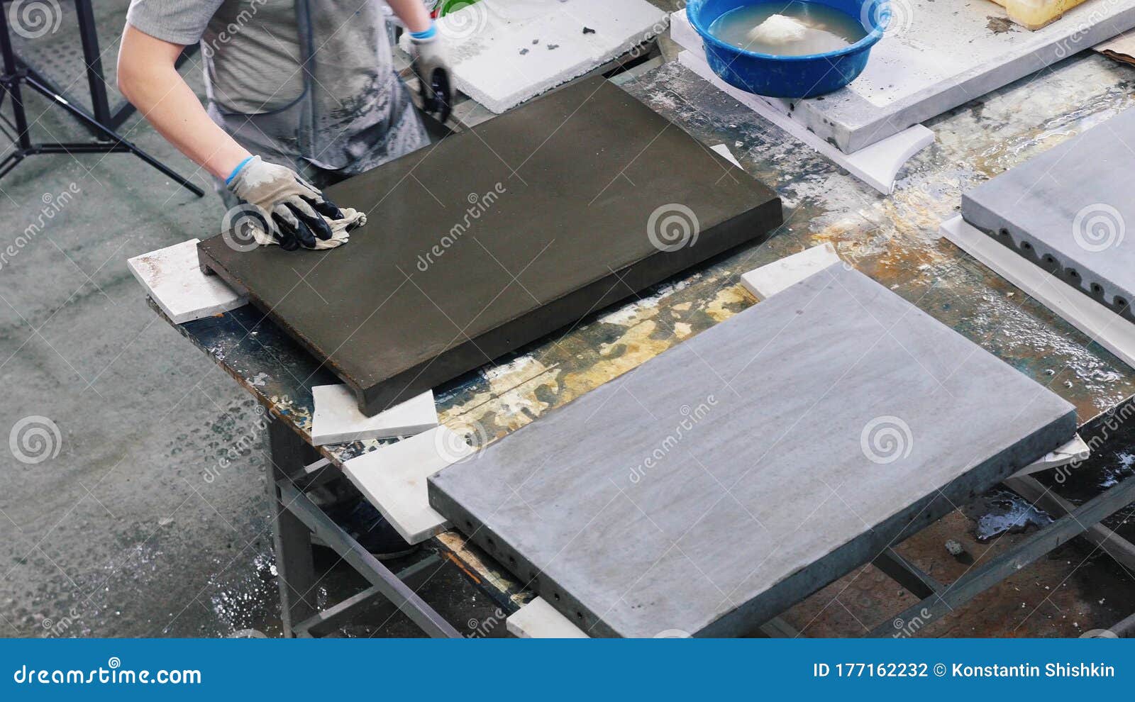Concrete Workshop - Man is Wiping Concrete Slabs with a Rag Stock Photo ...