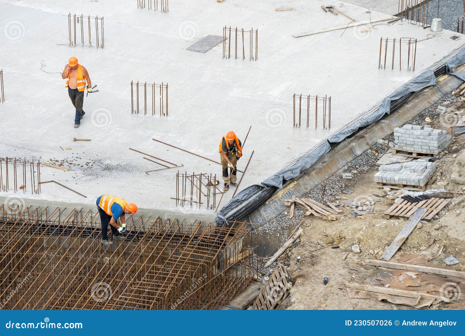 Concreting Work: Construction Site Worker during Concrete Pouring into ...