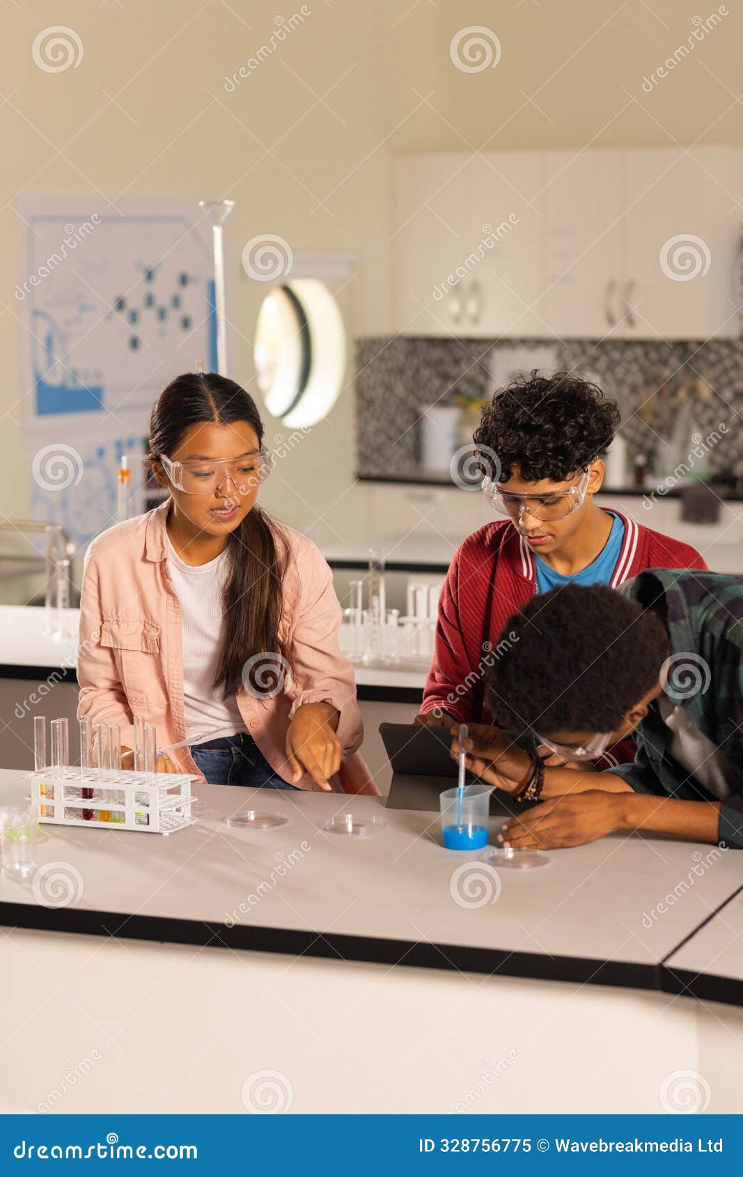 Conducting Science Experiment with Test Tubes and Tablet, Students in ...
