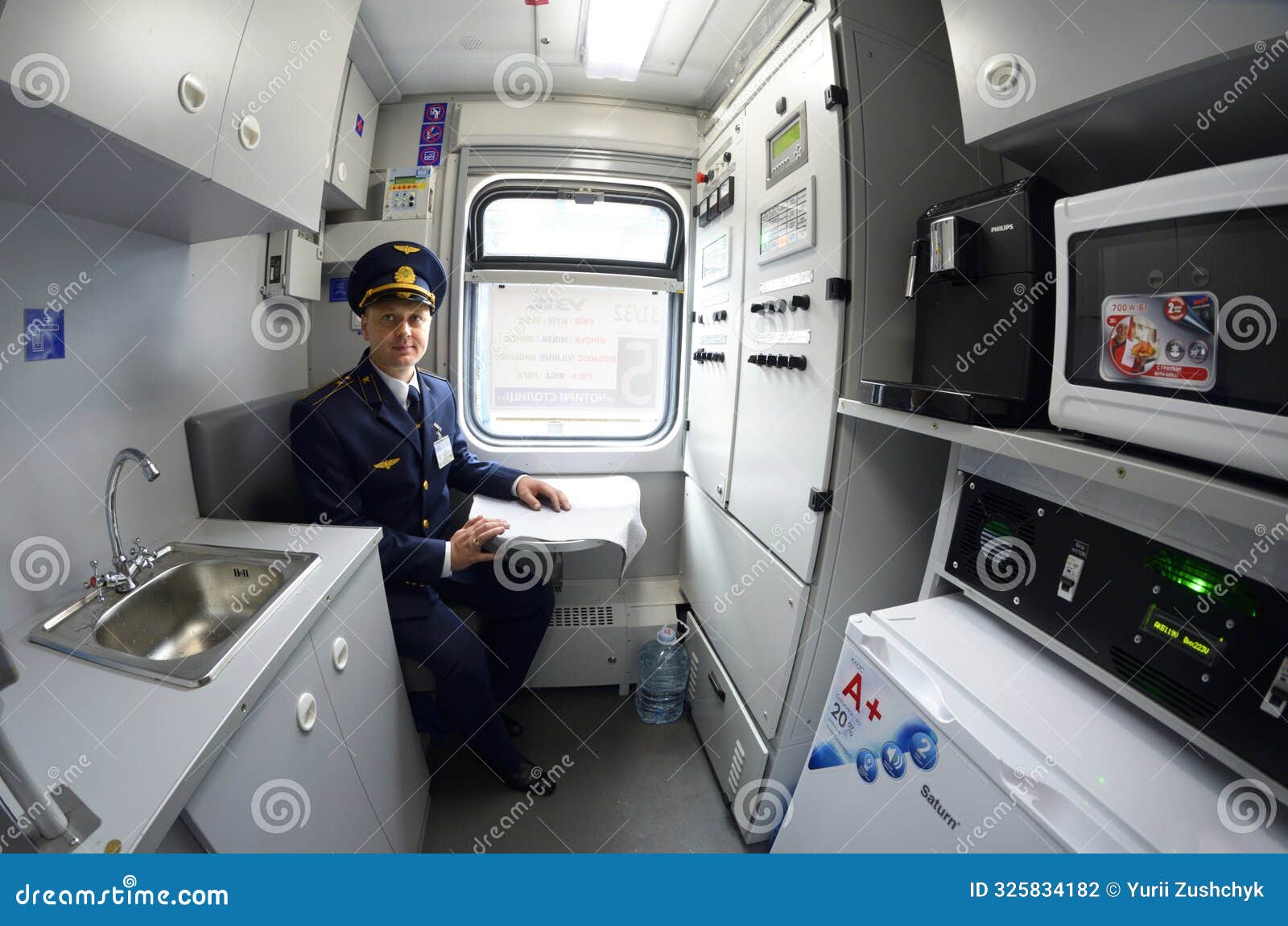 Conductor Man Sitting in Front of a Window at the Service Compartment ...