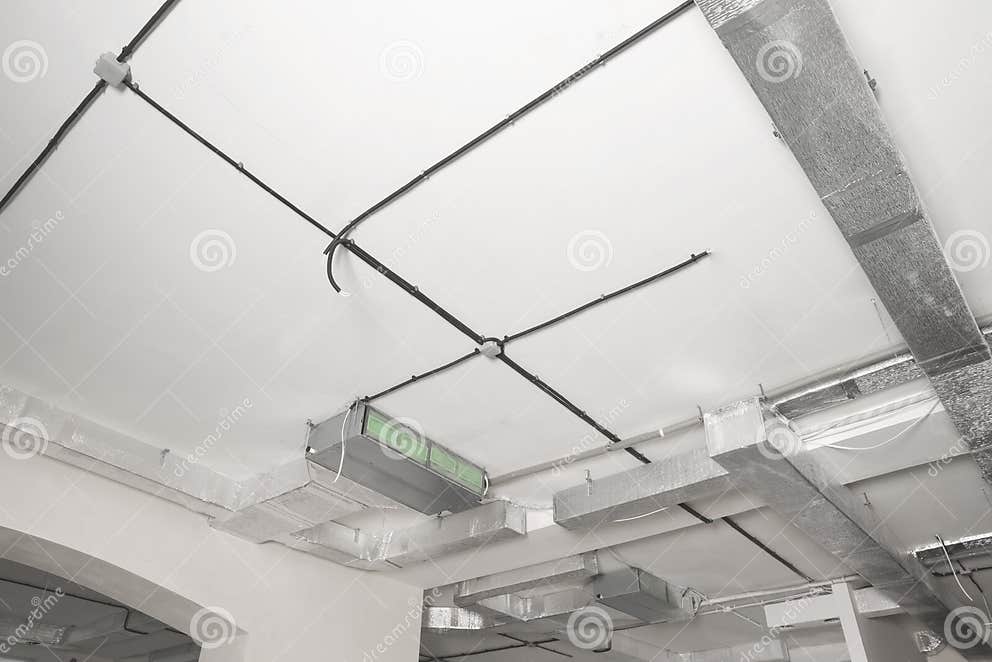 Conduits with Cables and Ventilation System on White Ceiling, Low Angle ...