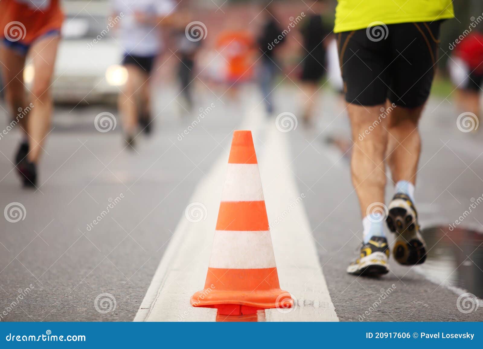 Cone on Road between Running People Stock Photo - Image of cone ...