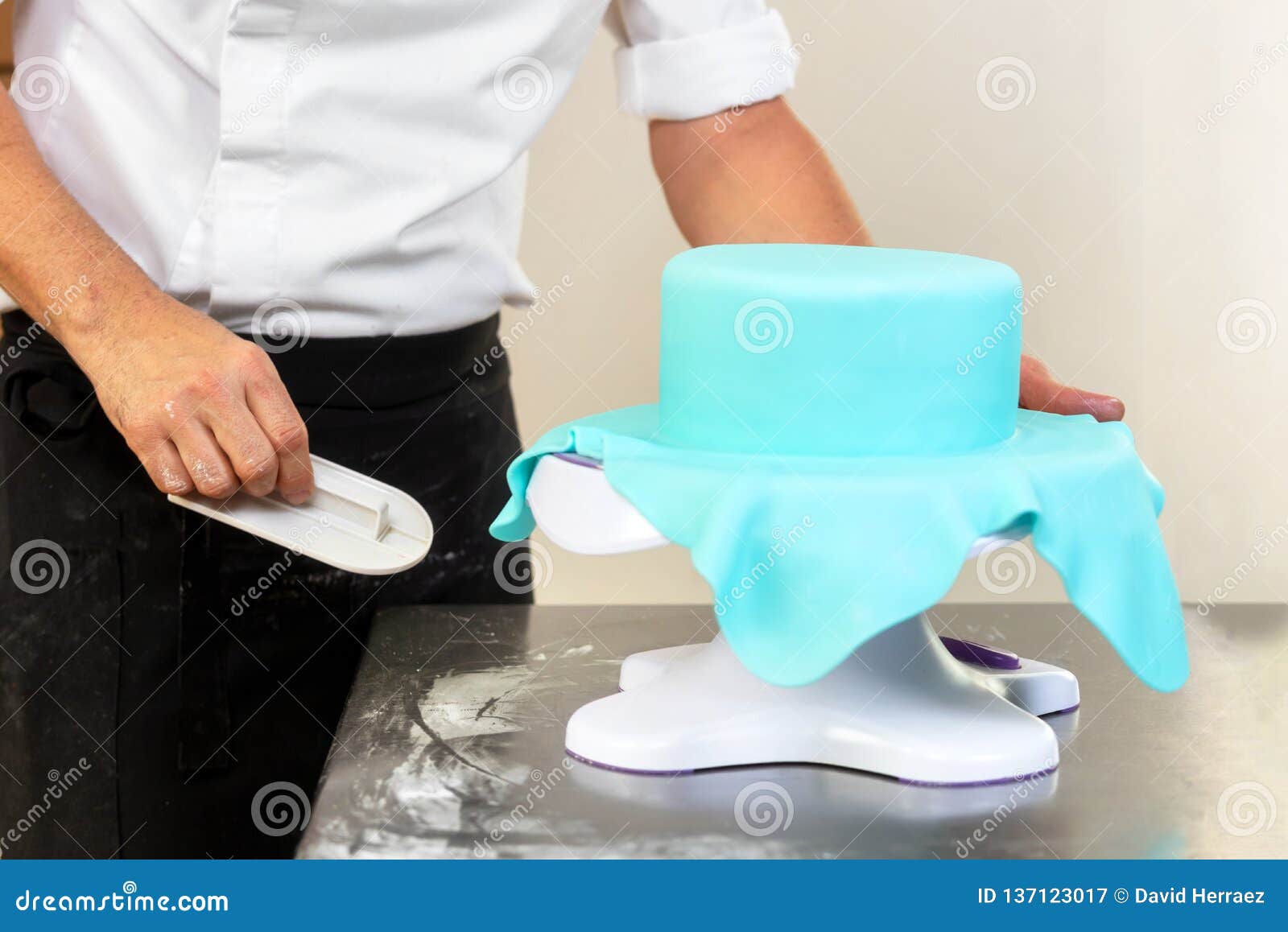 Confectioner Decorating a Wedding Cake with Blue Fondant. Stock Image ...