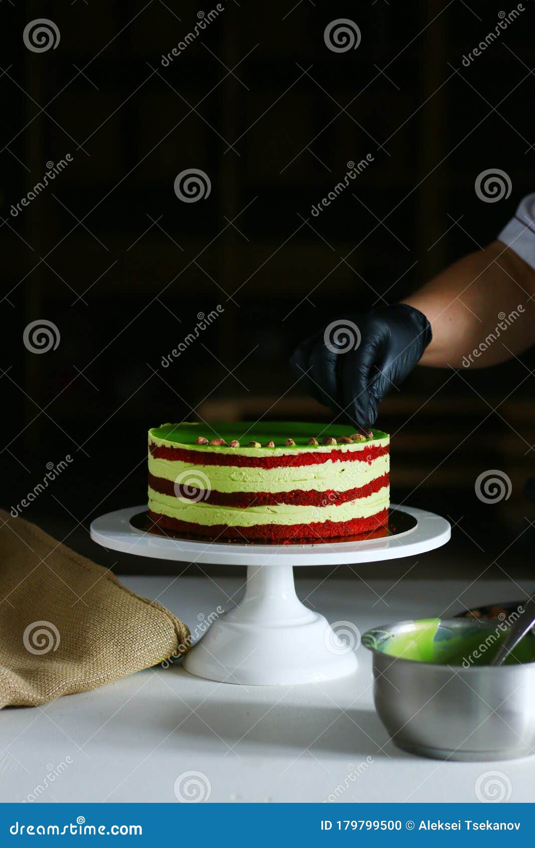 Confectioner Hand Process Pistachino Cake Closeup on Dark Background ...