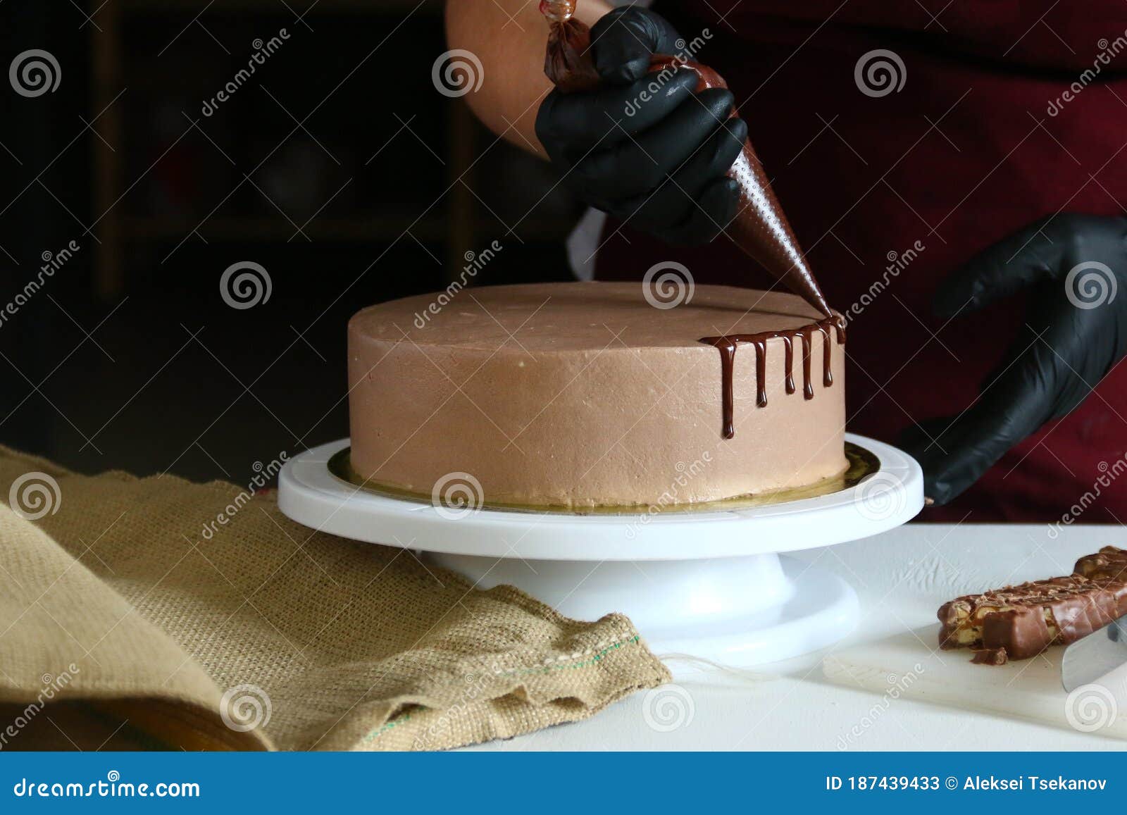 Confectioner Process Chocolate Cake On Table. The Process Of Decorating ...