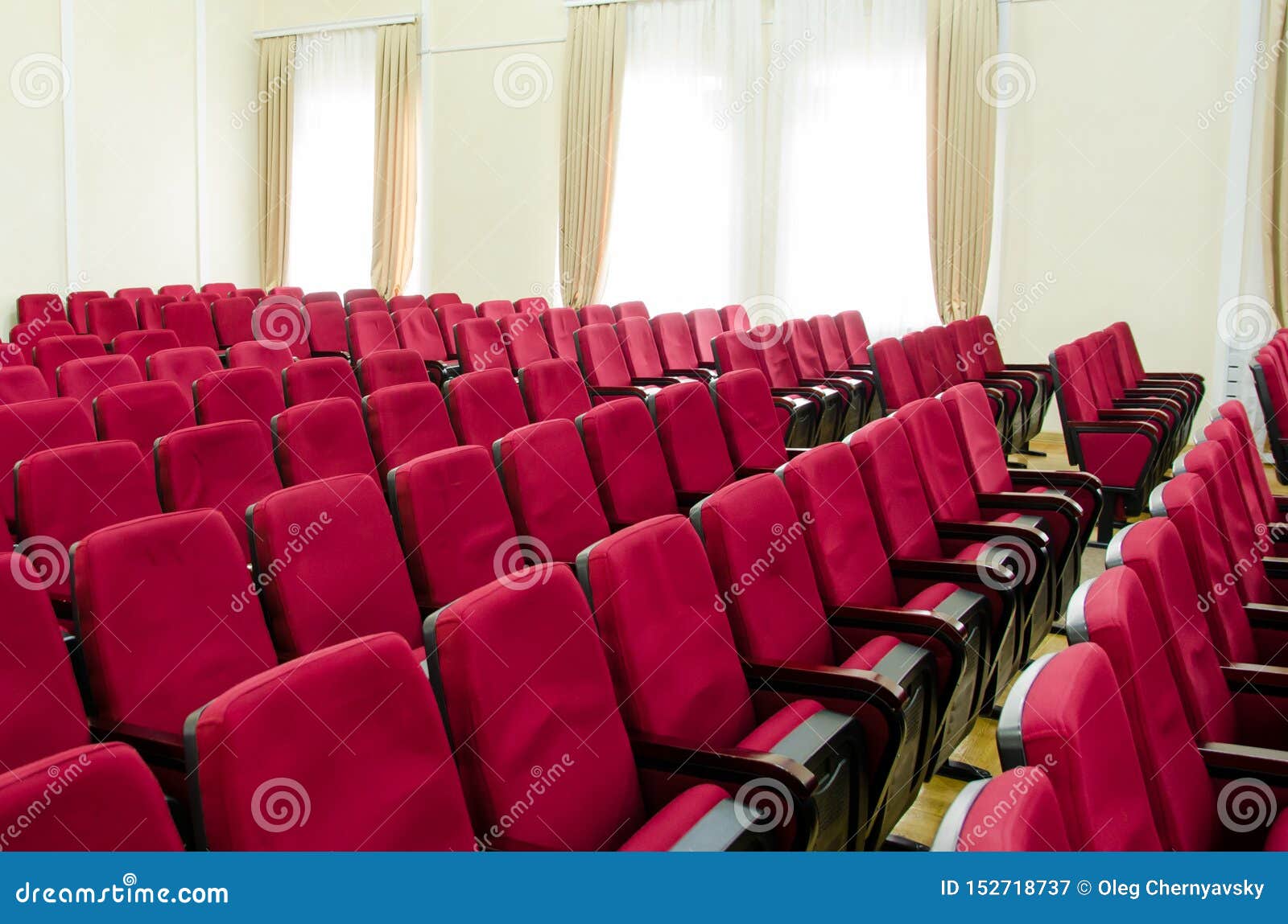 Conference Hall with Red Comfortable Chairs and Beige Walls with ...