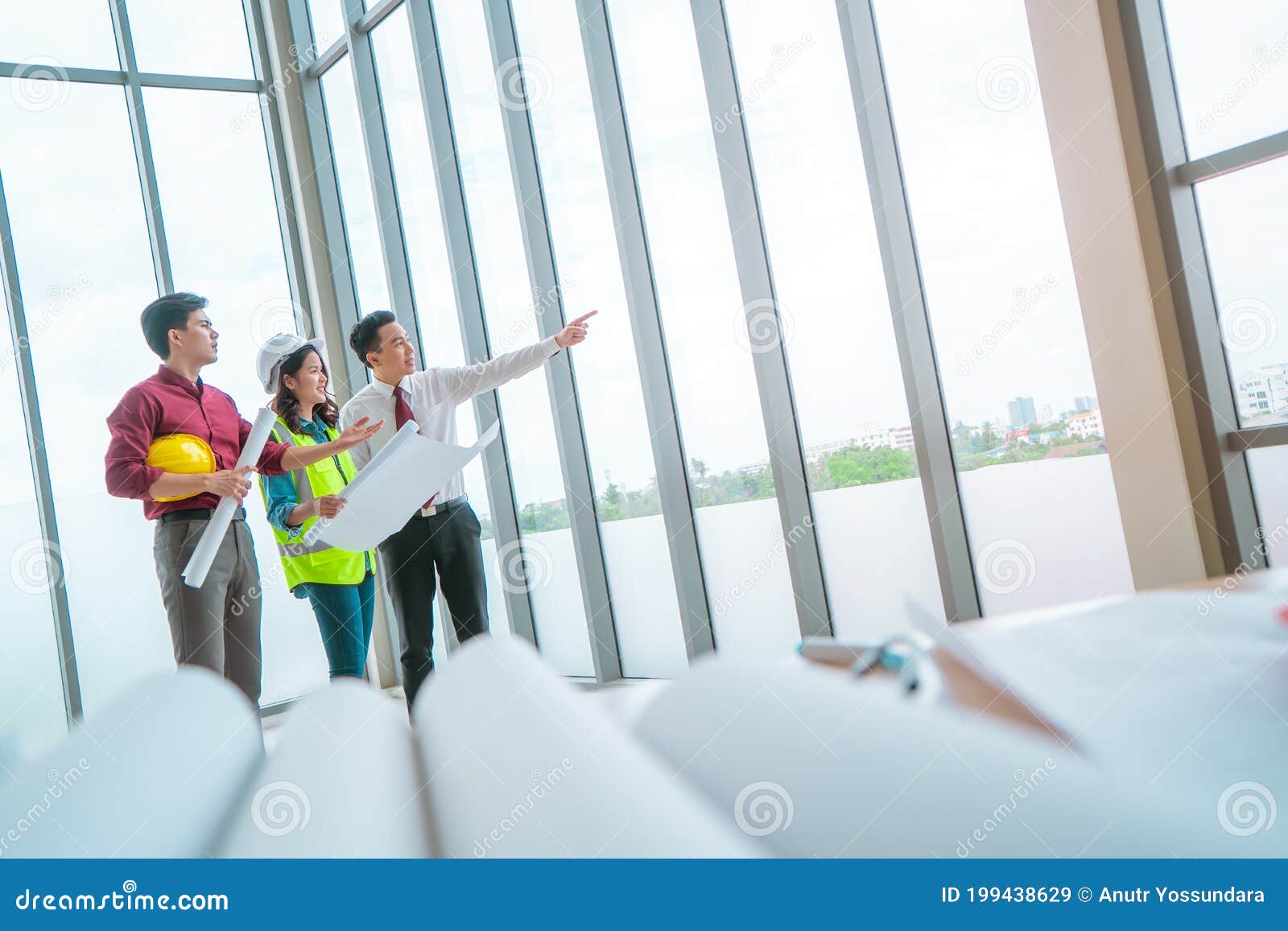 Confidence Construction Team Looking Out the Windows To the ...