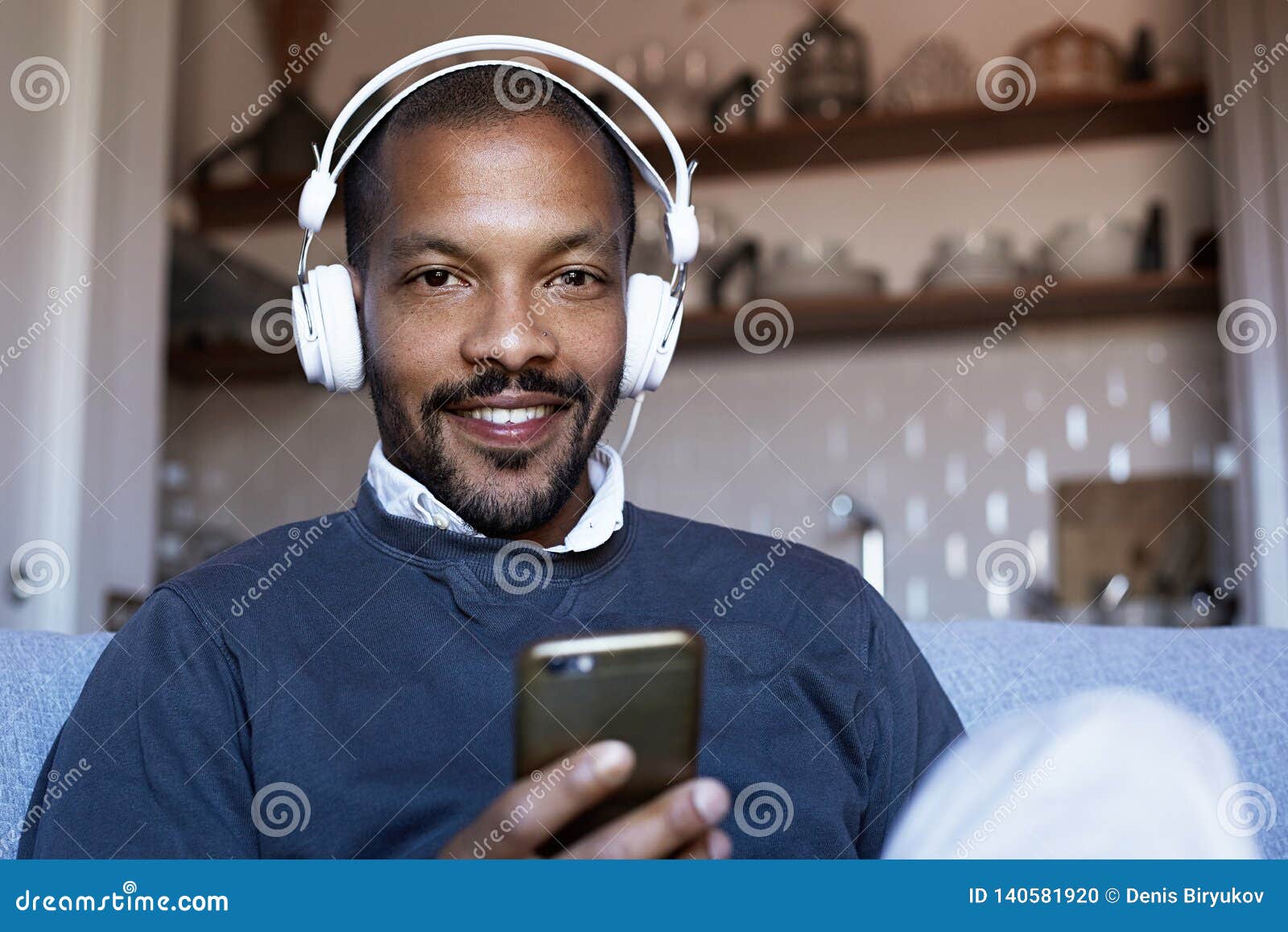 Confident African American Man With Headphones Listening To Music On