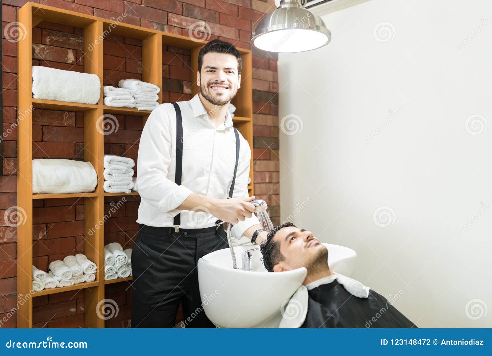 Barber Smiling while Washing Customer`s Hair with Shower Stock Photo ... Barber Smiling while Washing Customer`s Hair with Shower Stock Photo ...
