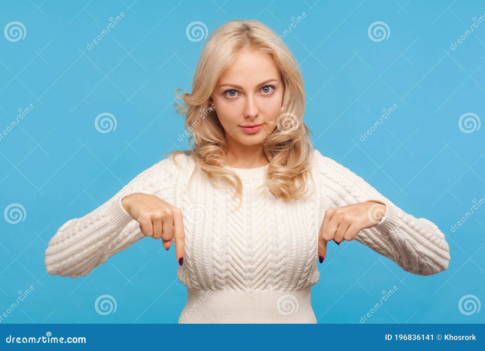Confident Bossy Blond Woman In White Knitted Sweater Pointing Fingers