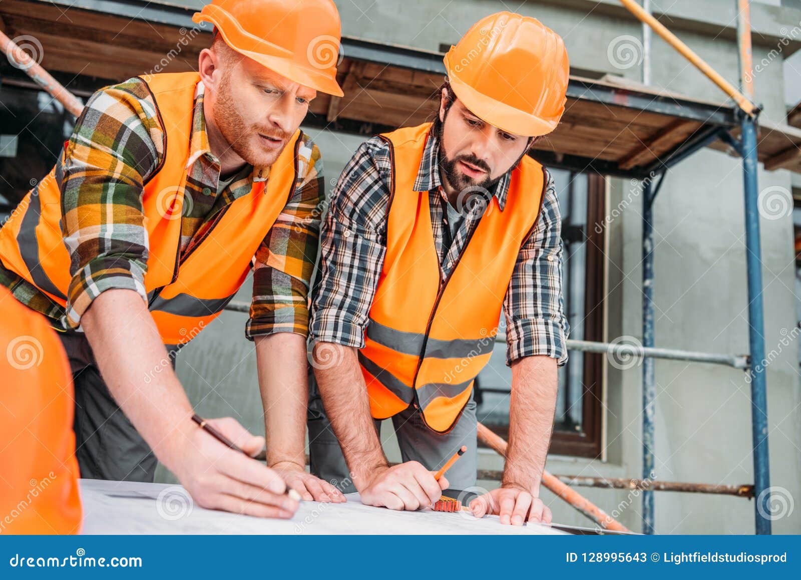 Confident Builders Drawing Building Plan Stock Image - Image of male ...
