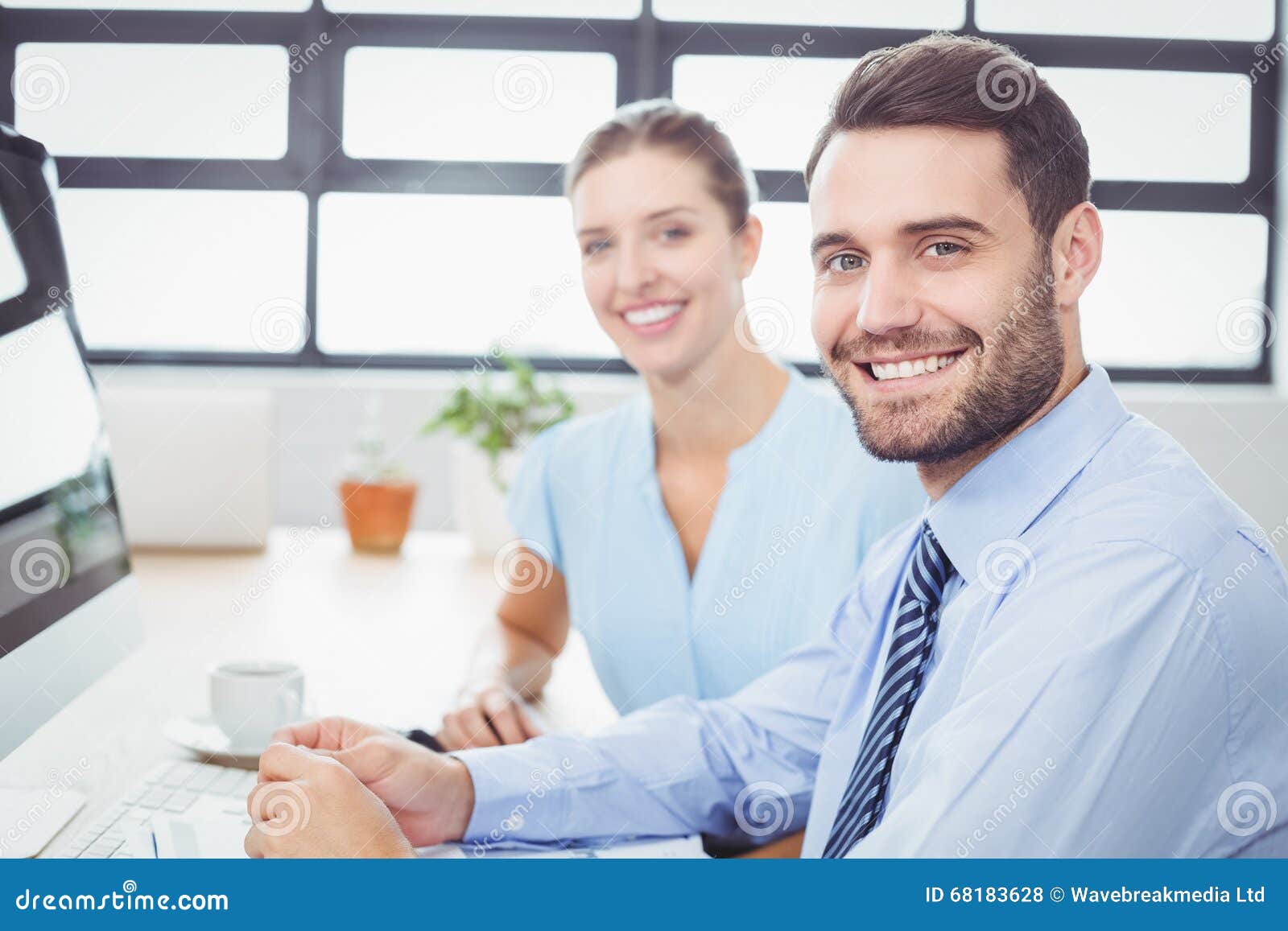Confident Business People Sitting at Computer Desk Stock Photo - Image ...