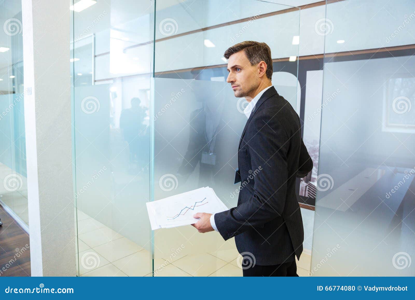 Confident Businessman Holding Documents and Entering the Office Stock ...