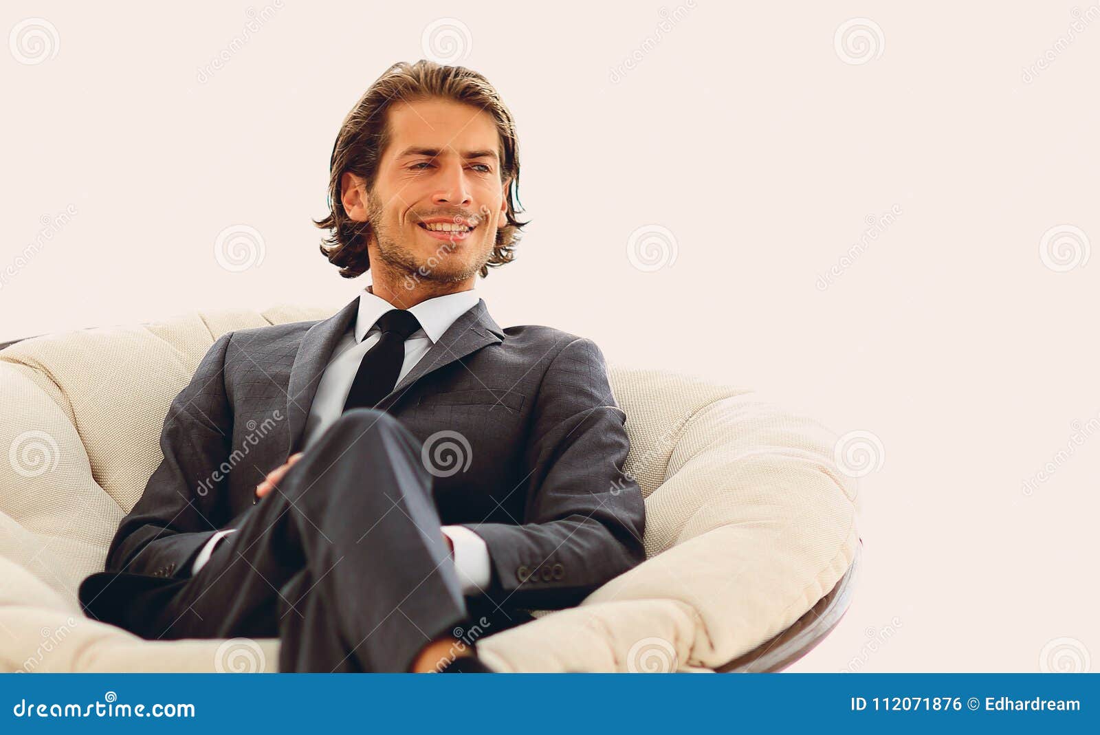 Confident Businessman Sitting in a Large Comfortable Chair. Stock Photo ... Confident Businessman Sitting in a Large Comfortable Chair. Stock Photo ...
