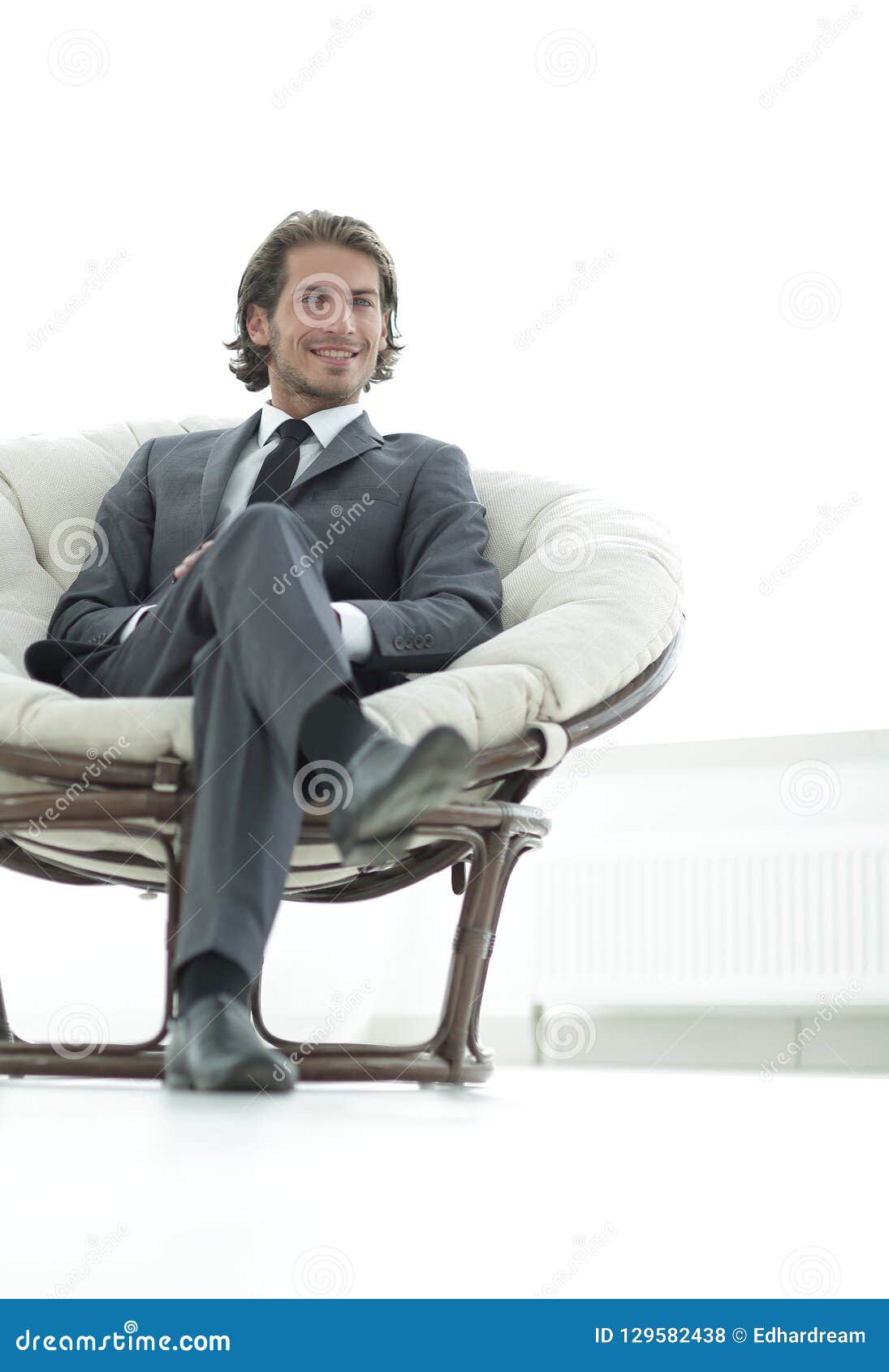 Confident Businessman Sitting in a Large Comfortable Chair. Stock Photo ... Confident Businessman Sitting in a Large Comfortable Chair. Stock Photo ...