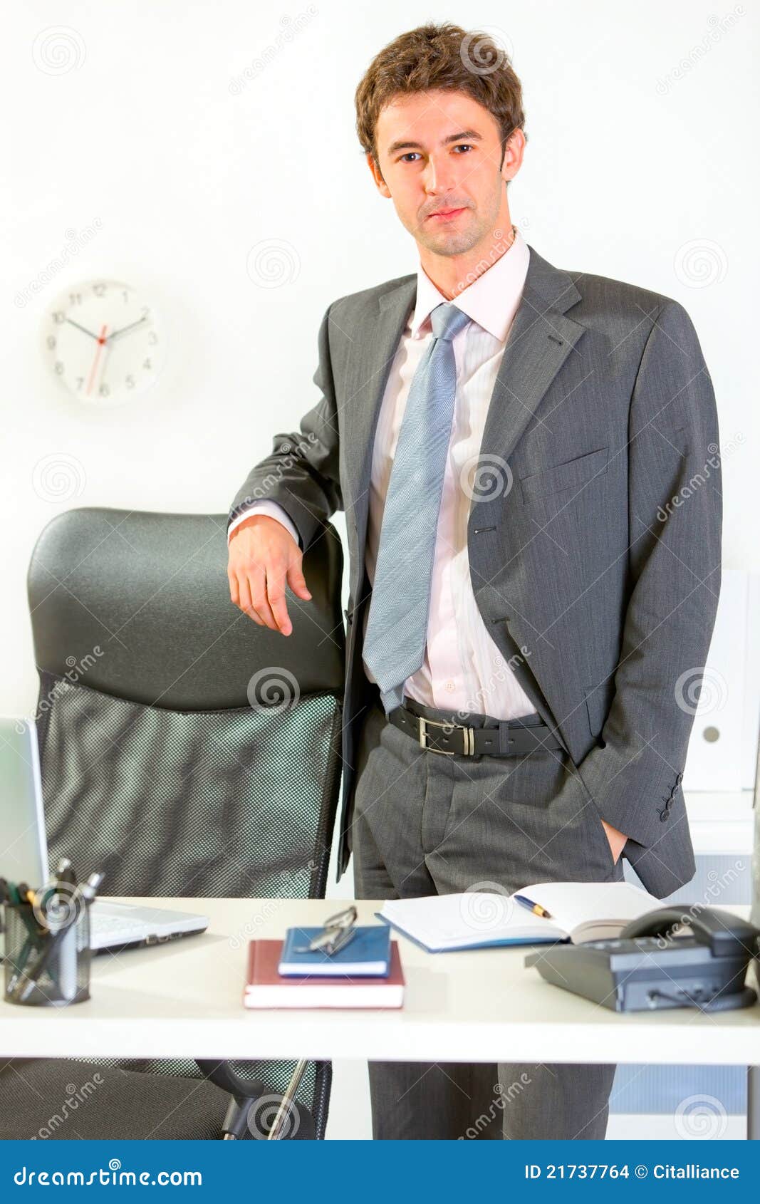 Confident Businessman Standing at Office Desk Stock Photo - Image of ... Confident Businessman Standing at Office Desk Stock Photo - Image of ...