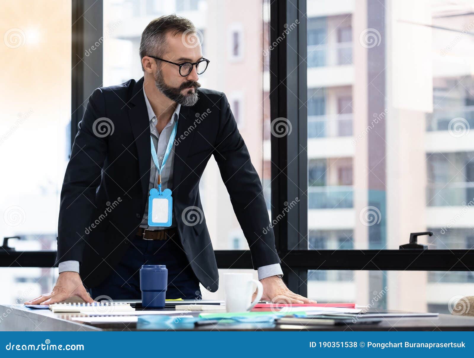 Confident Businessman Standing at the Table and Two His Hand Touch on ...
