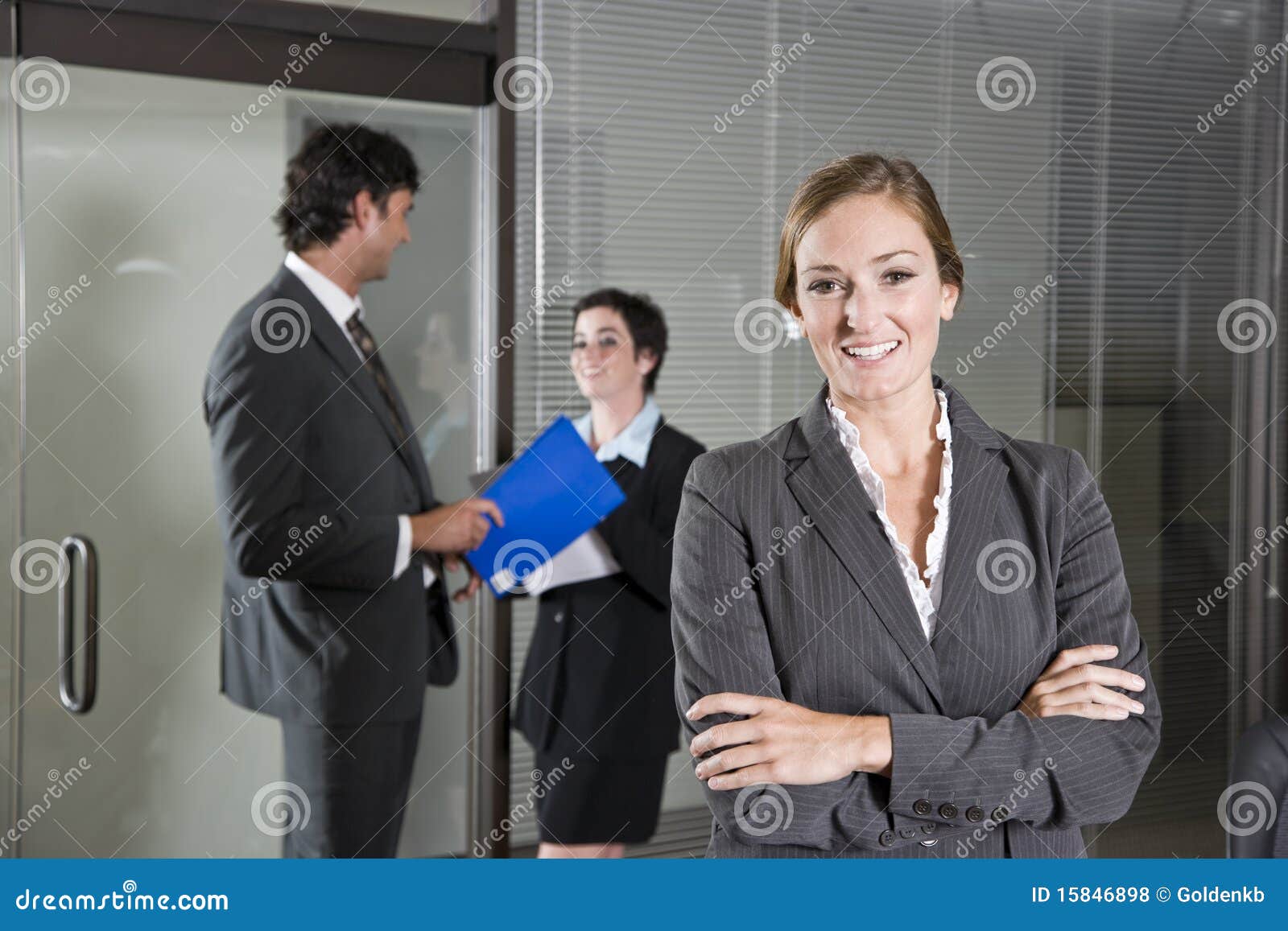 Confident Businesswoman, Colleagues in Background Stock Photo - Image ...