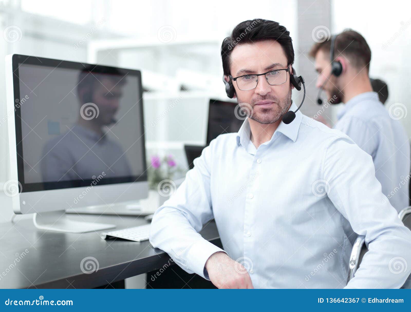 Confident Call Center Manager Sitting in Front of Computer Screen Stock ...