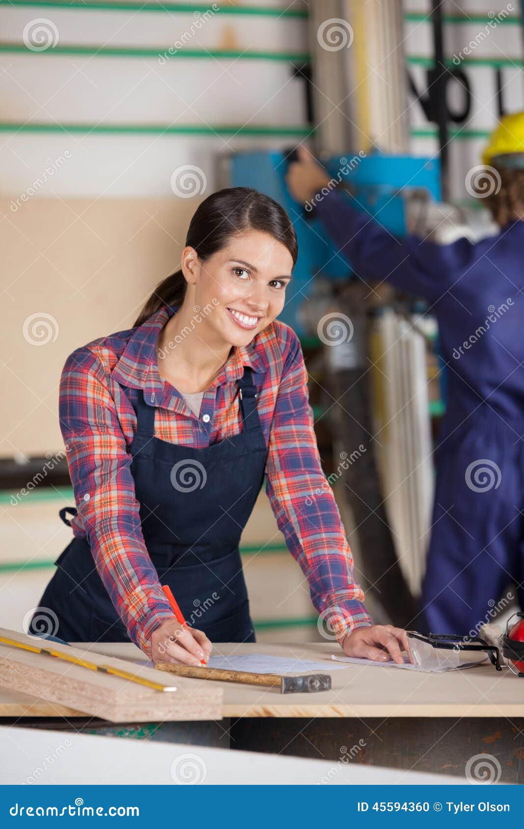 Confident Carpenter Writing on Document in Stock Photo - Image of ...