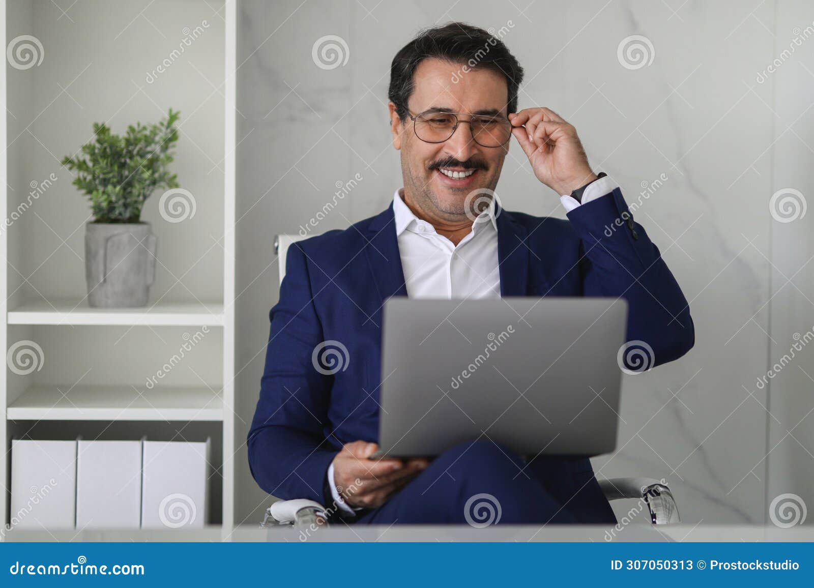 Confident And Cheerful Mature Businessman In Blue Suit Adjusting