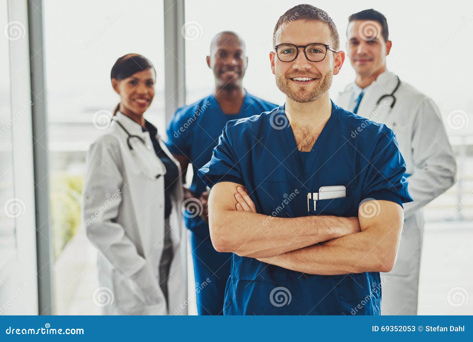 Confident Doctor in Front of Group Stock Image - Image of friendly ...