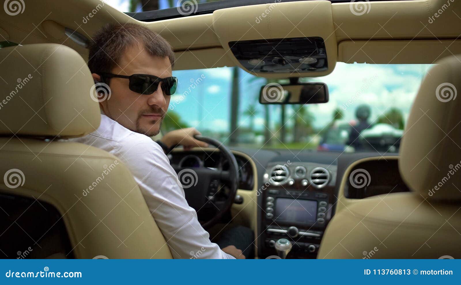 Confident Driver in Sunglasses Watching at Back Seat, Hearing Boss ...