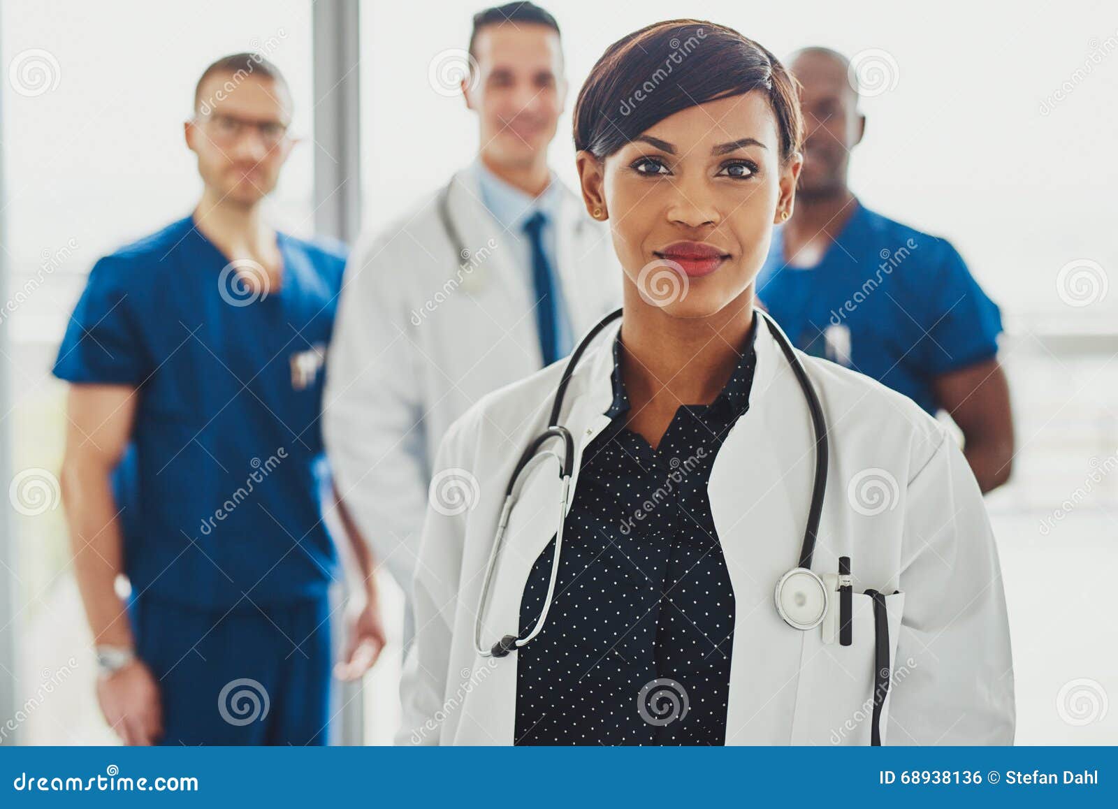 Confident Female Doctor in Front of Team Stock Photo - Image of ...