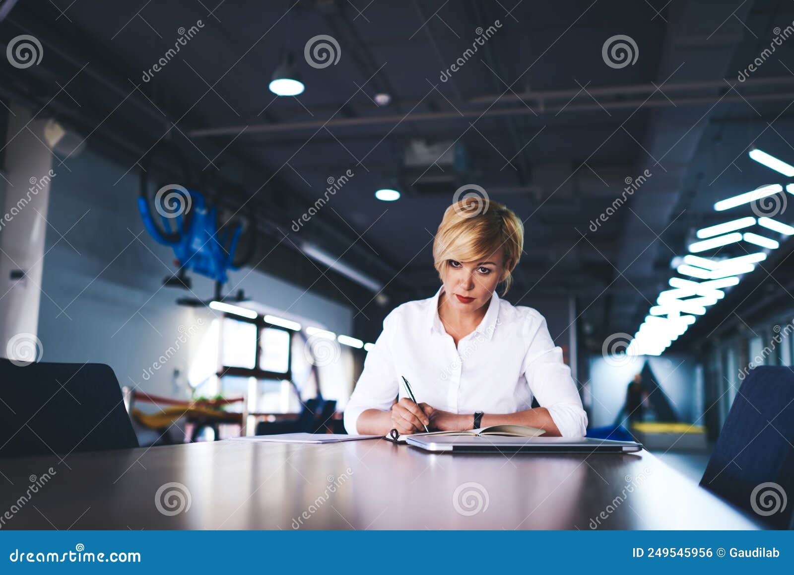 Focused Female Office Worker Taking Notes Stock Photo - Image of ...