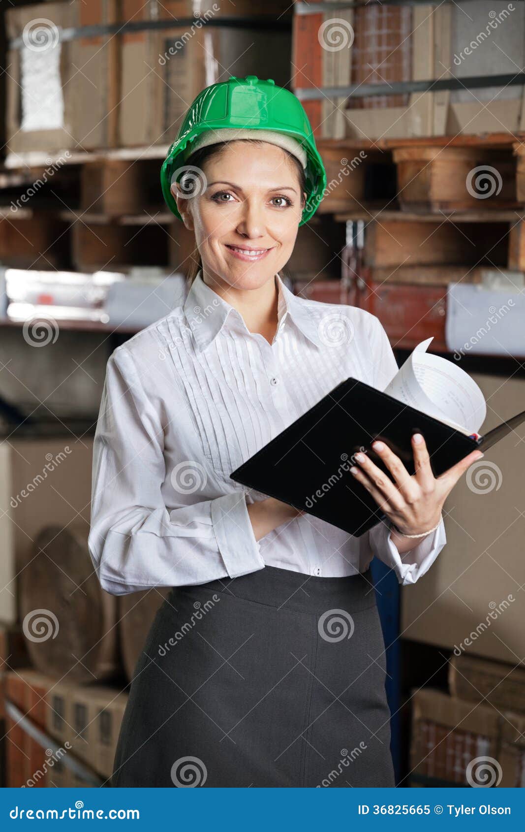 Confident Female Supervisor with Book at Warehouse Stock Image - Image ...
