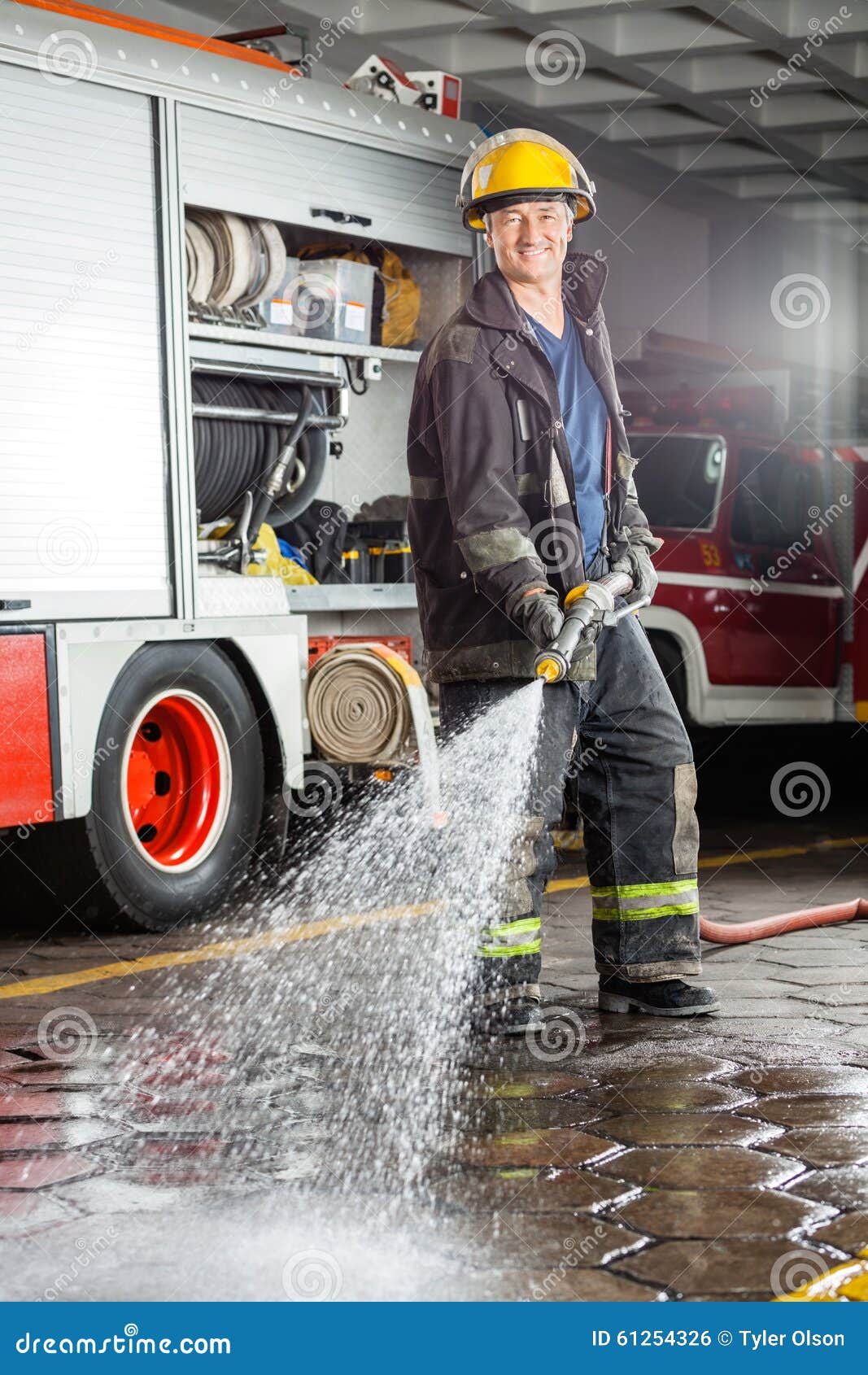 Confident Fireman Spraying Water during Practice Stock Photo - Image of ...