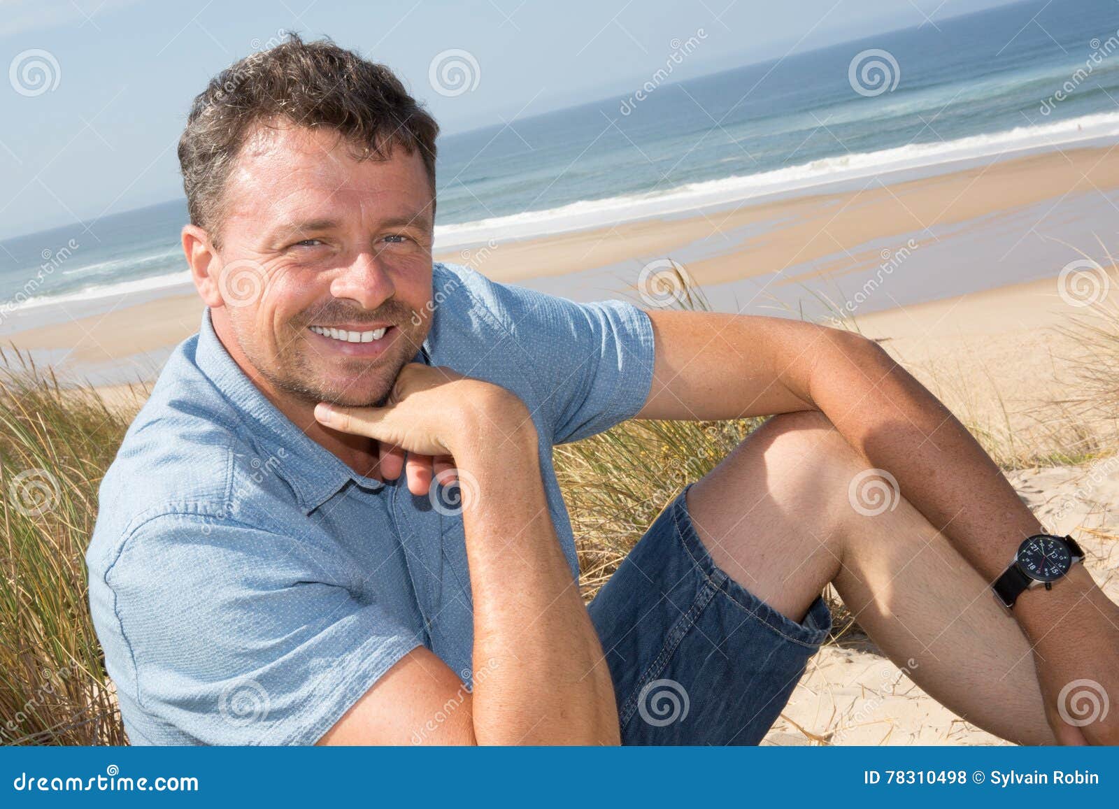 Confident and Handsome Man Sitting on Beach Stock Photo - Image of hair ...