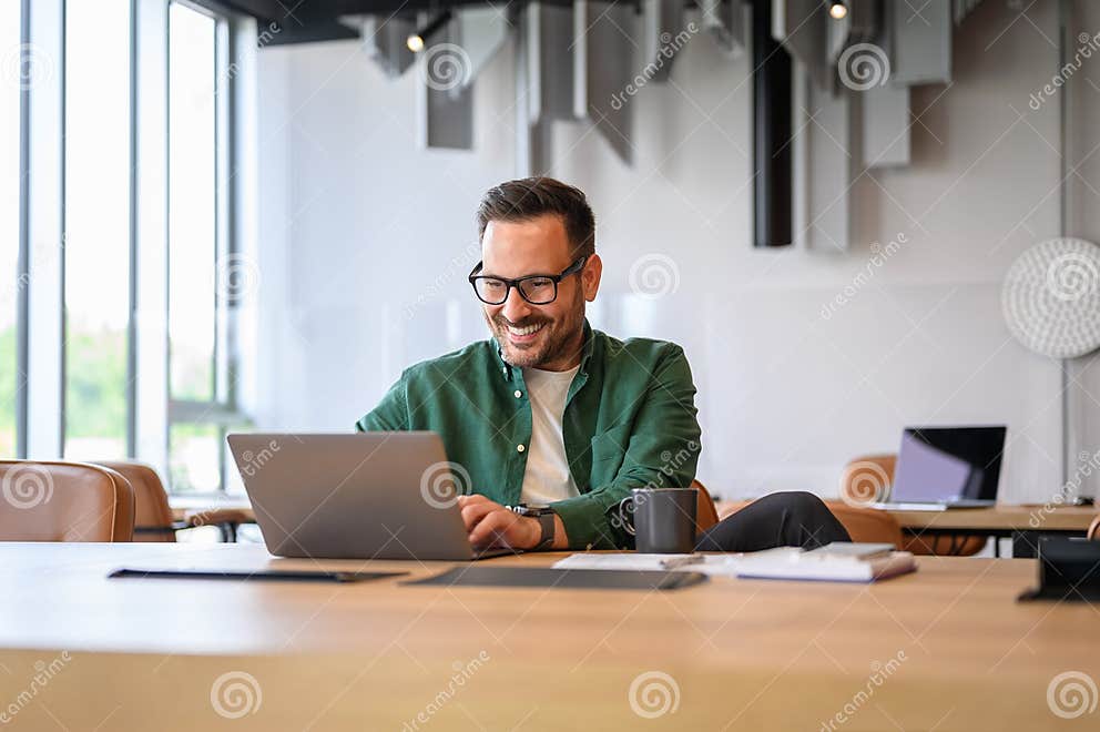 Confident Handsome Programmer in Eyeglasses Developing Software Over ...